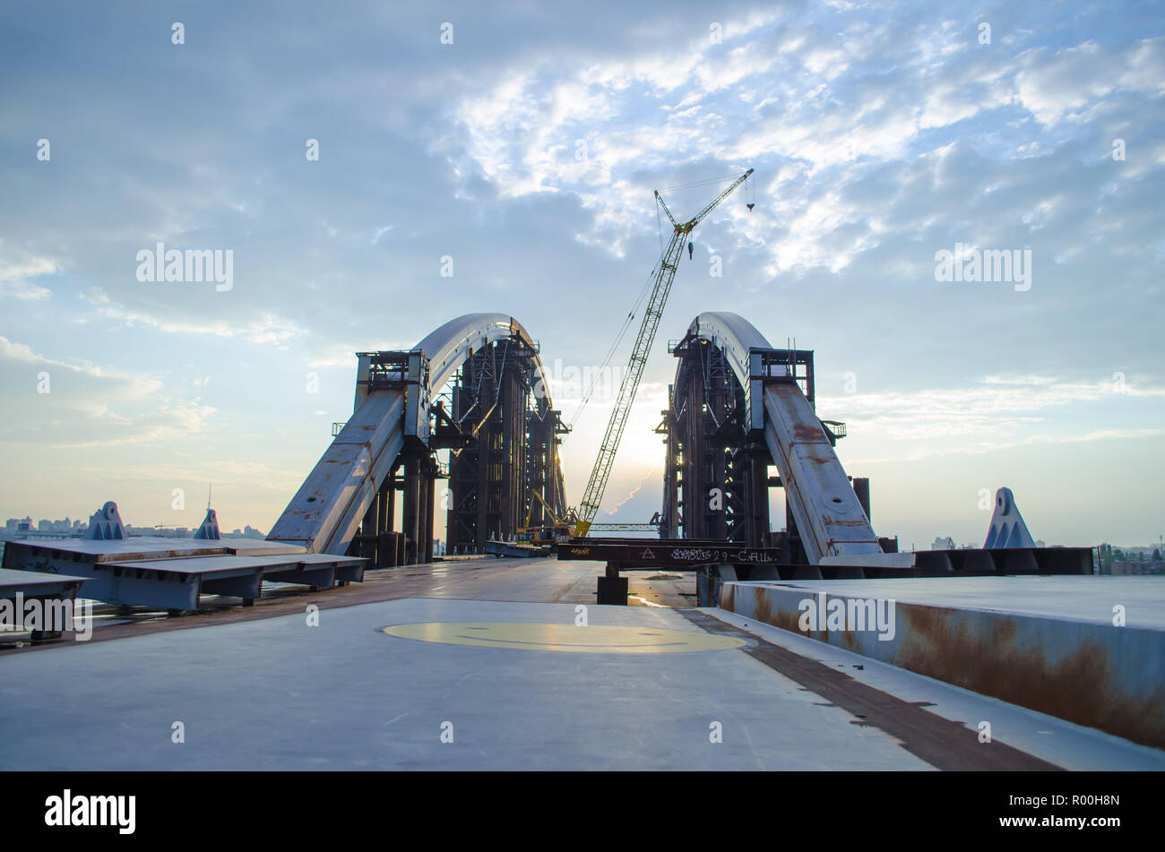 Unfinished metal bridge. Abandoned industrial landscape at sunset Stock ...