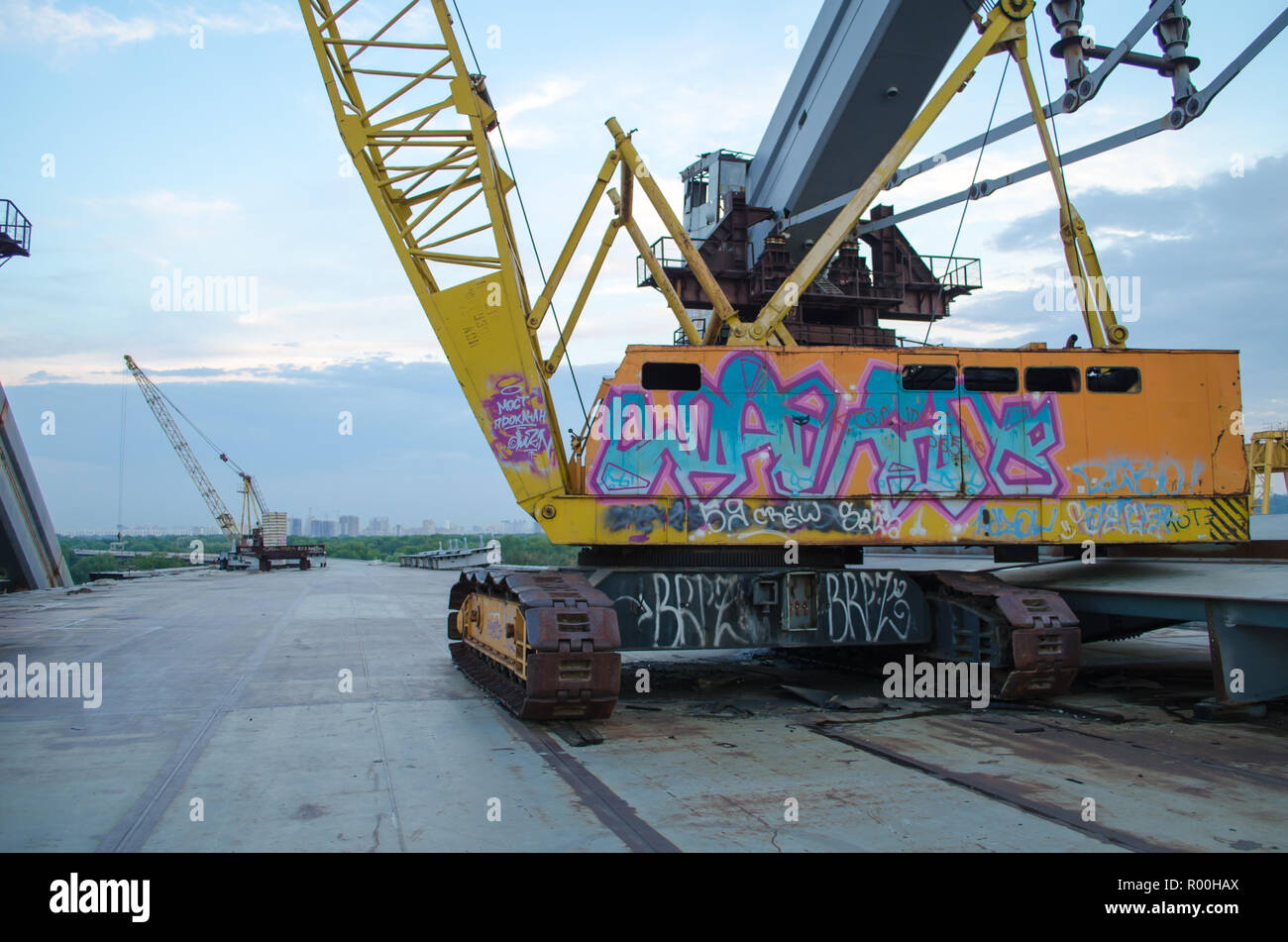 Abandoned construction crane with graffiti. Industrial rusty metal ...