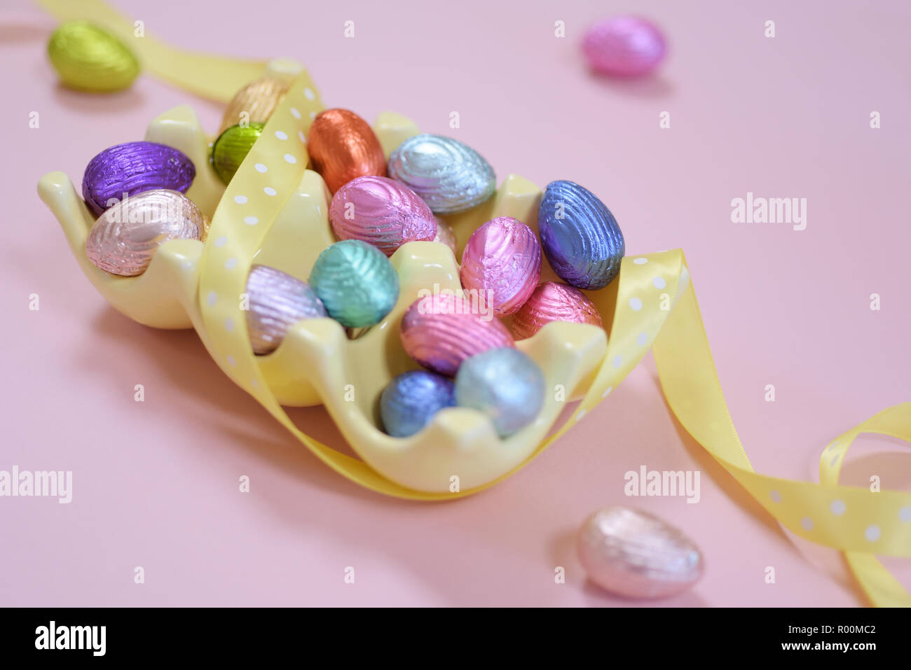 Yellow ribbon Egg box full of colourful Easter eggs Stock Photo - Alamy