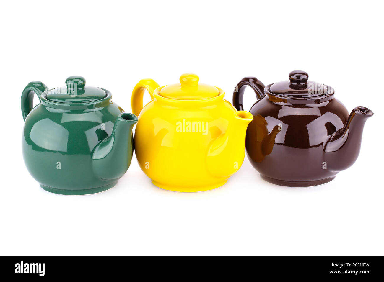 Green, yellow and brown teapots isolated on a white background Stock ...