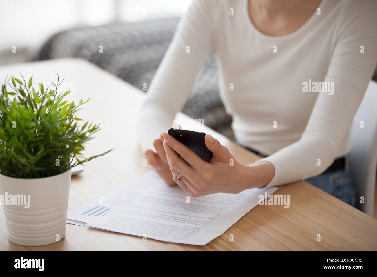Close up woman holding typing on mobile phone Stock Photo - Alamy