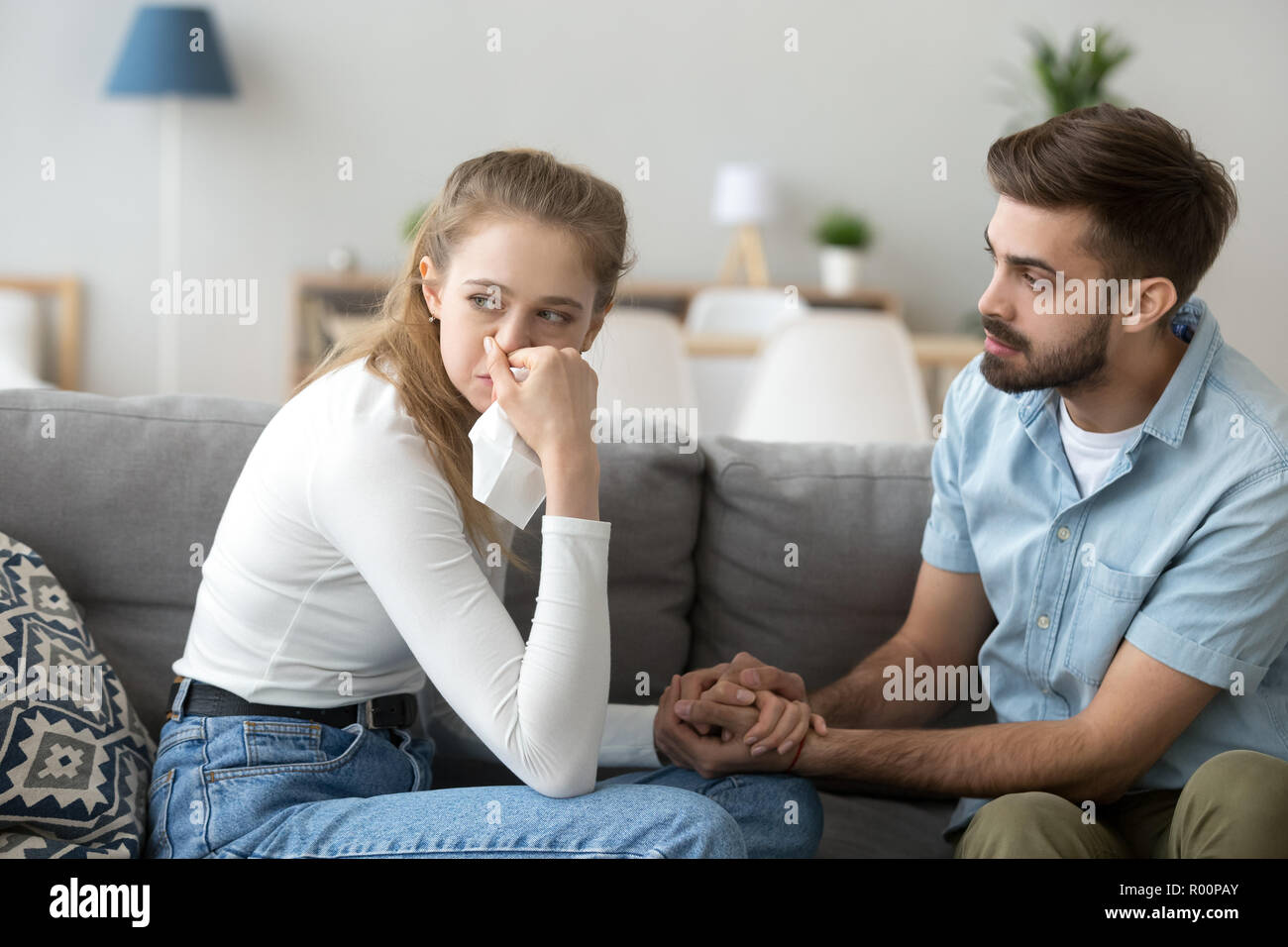 Couple woman crying on couch hi-res stock photography and images - Alamy