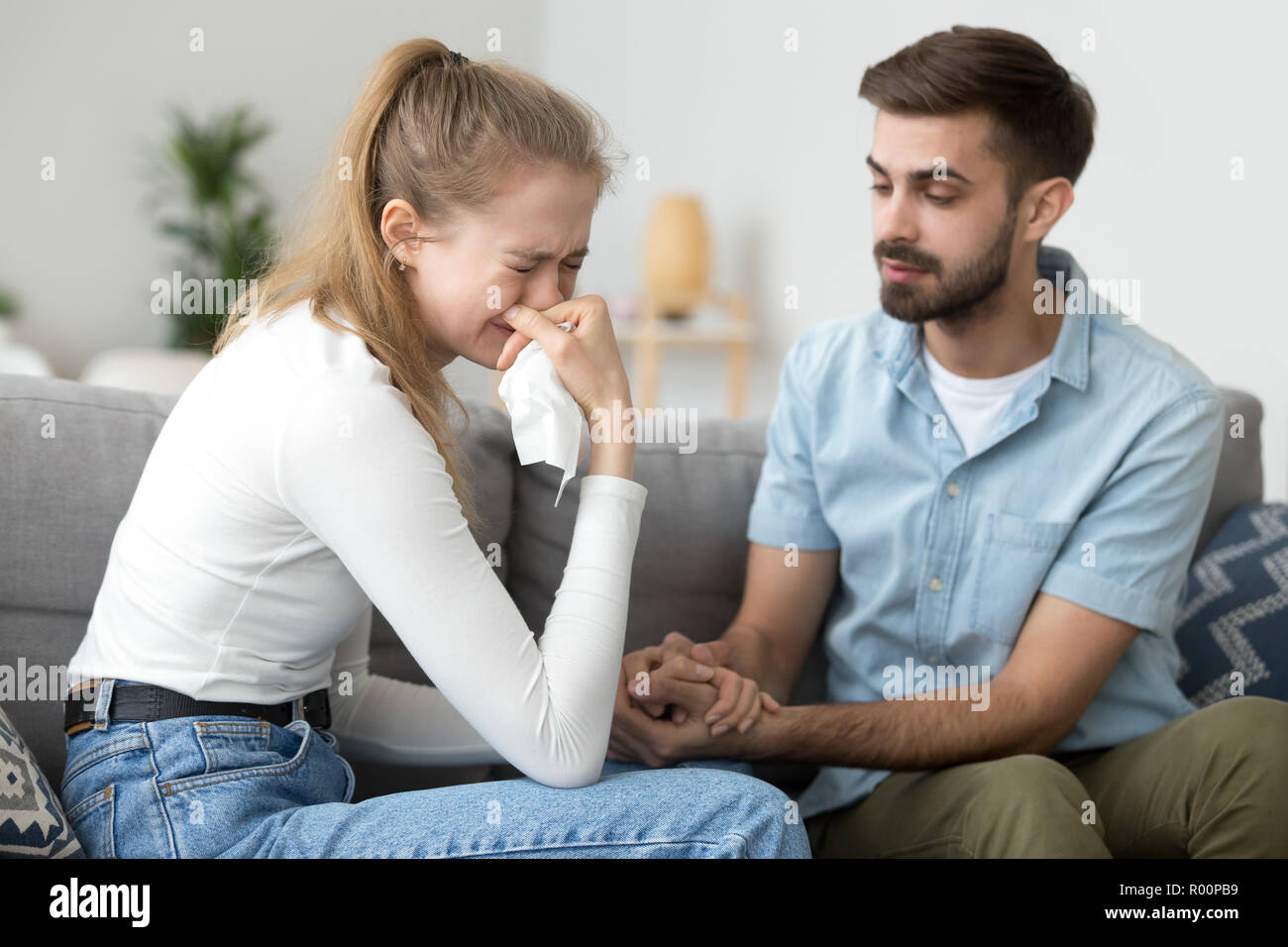 Couple woman crying on couch hi-res stock photography and images - Alamy