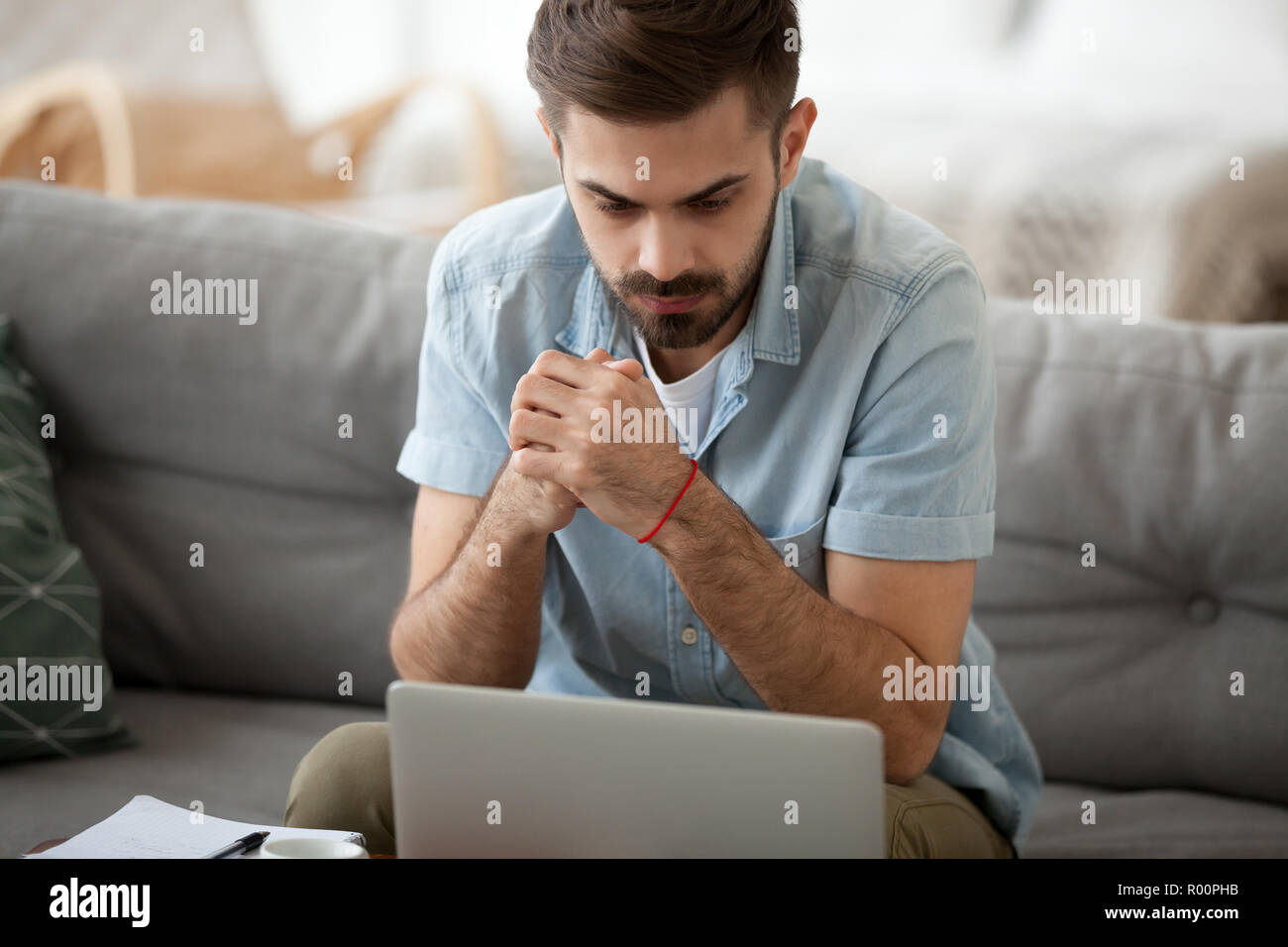 Man studying using computer reading message online Stock Photo - Alamy