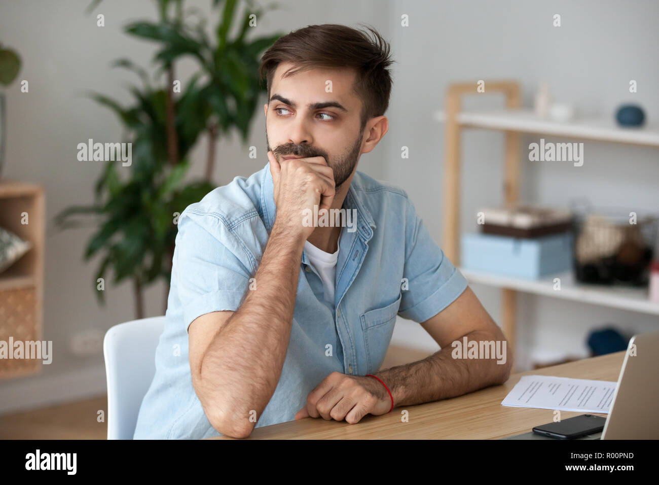Young concentrated male sitting hi-res stock photography and images - Alamy