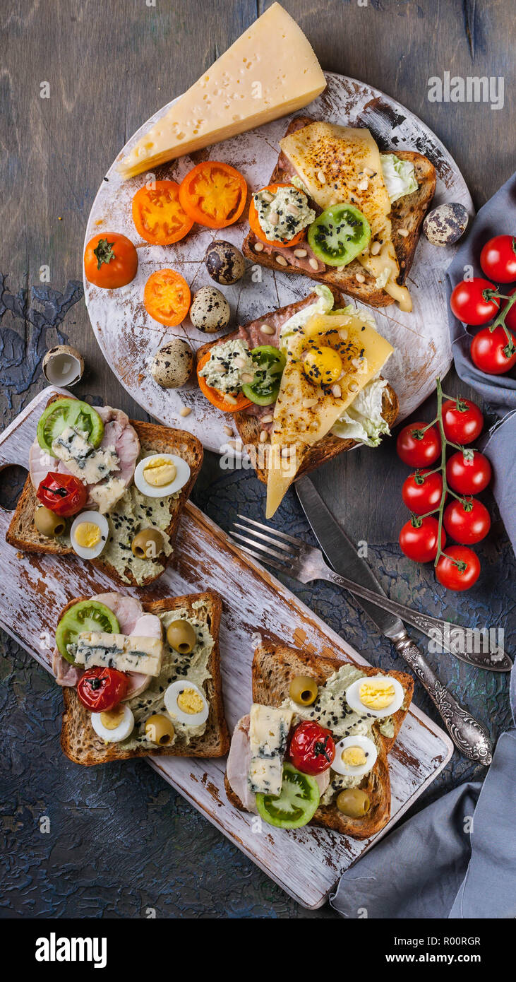 Vertical food banner. Delicious Toasts with grilled cheese, quail eggs ...