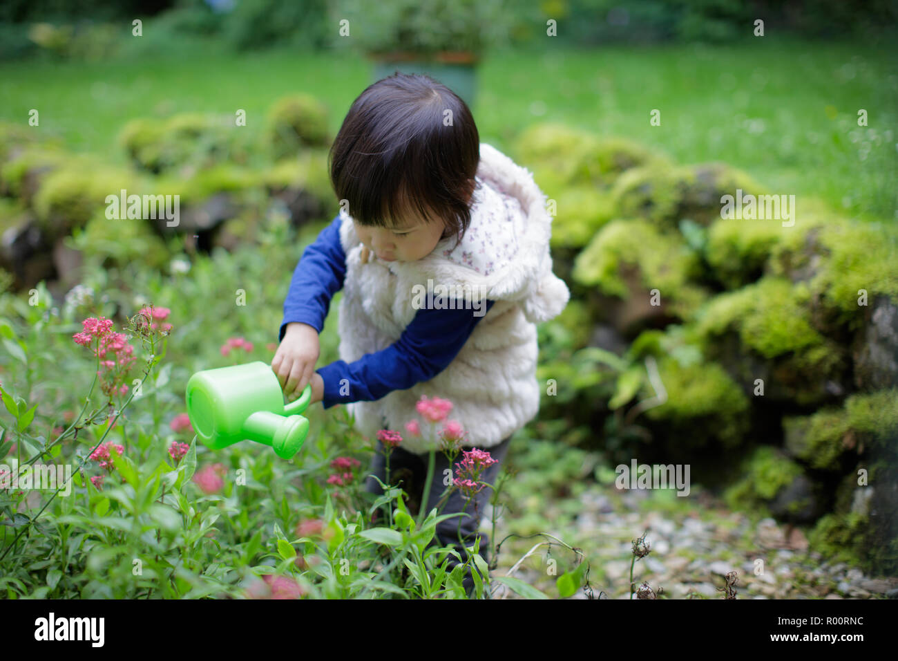 baby girl pretend play in garden Stock Photo - Alamy