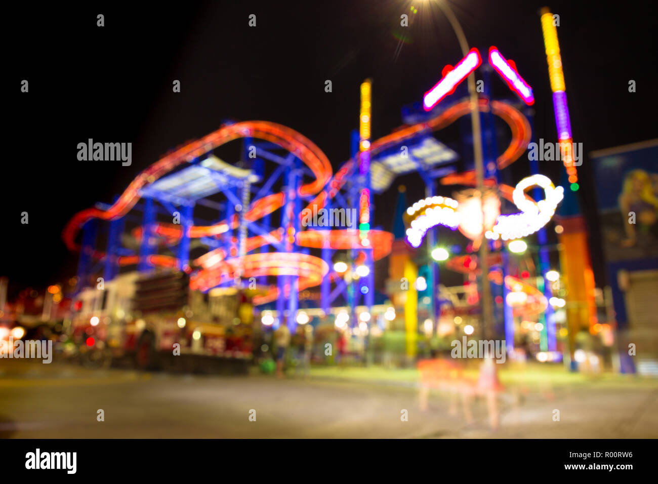 Defocused blurred view of roller coaster at night Stock Photo - Alamy