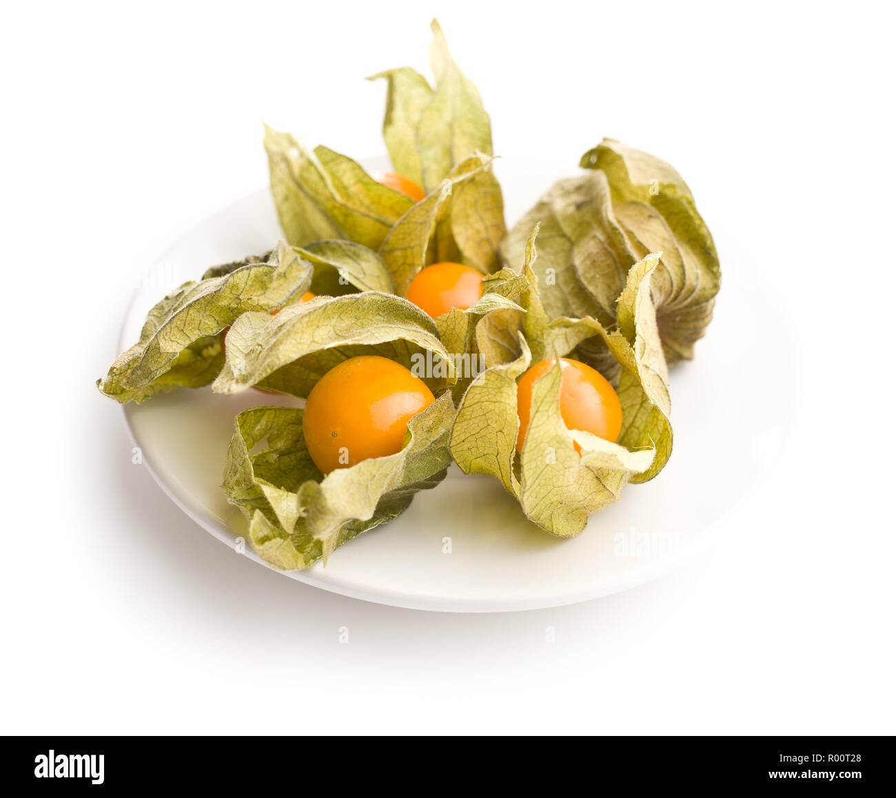 Physalis peruviana fruit on plate isolated on white background Stock ...