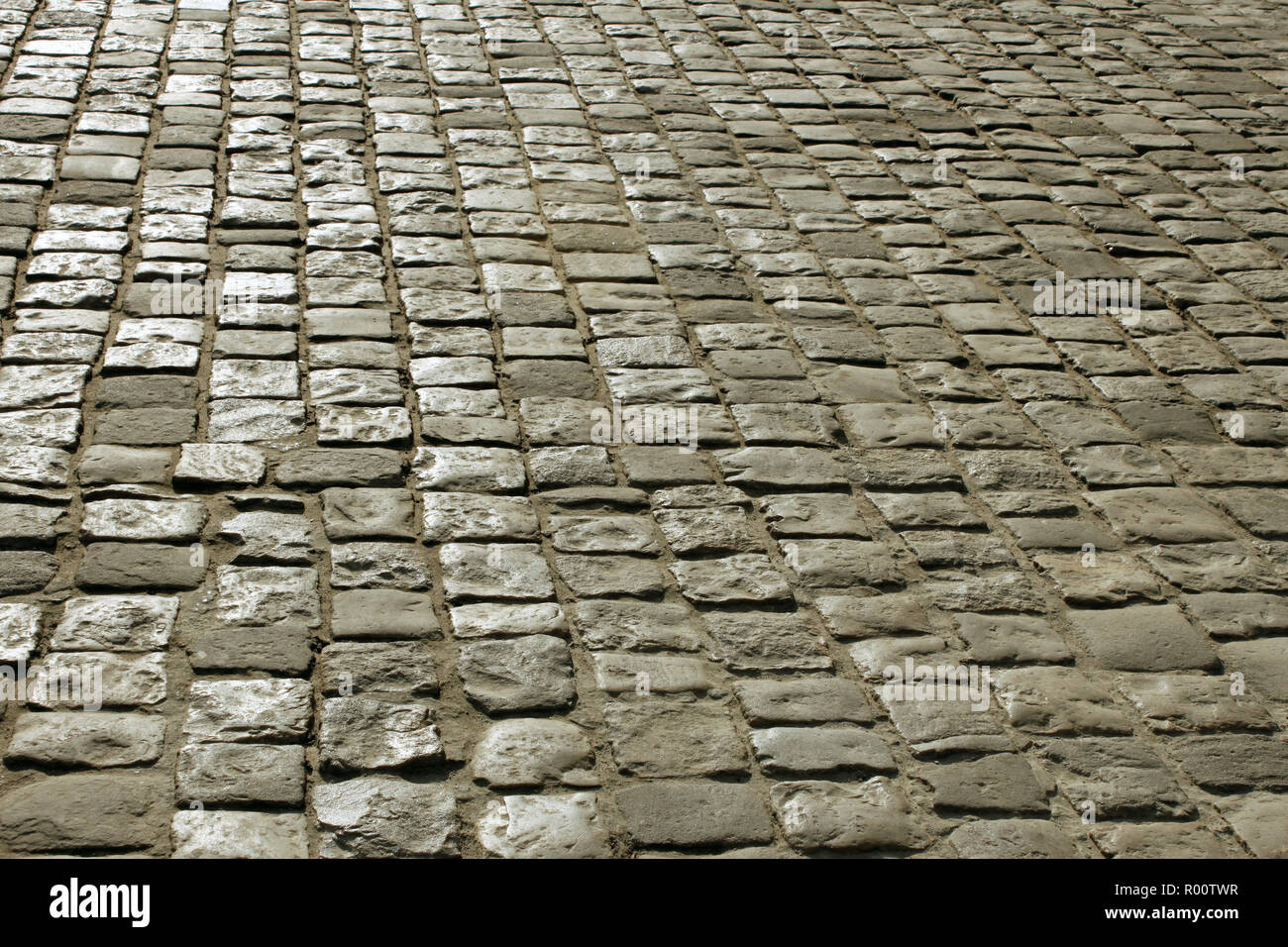 Part of urban square covered with cobblestone. Sunlight reflected on ...