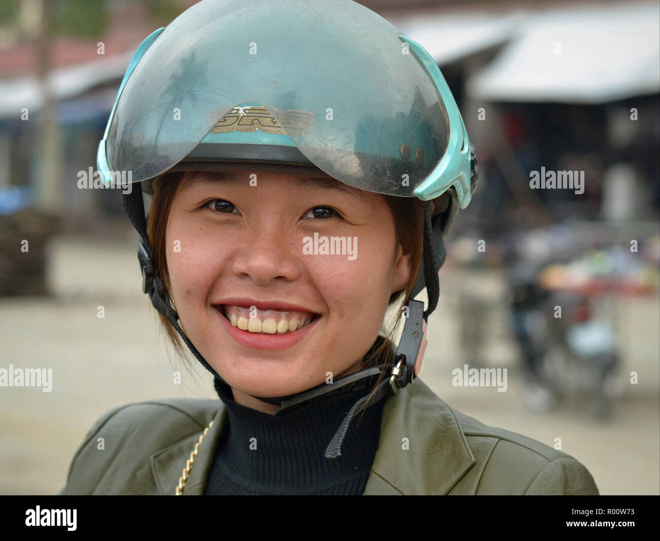 Smiling Vietnamese scooter girl with modern motorcycle crash helmet ...