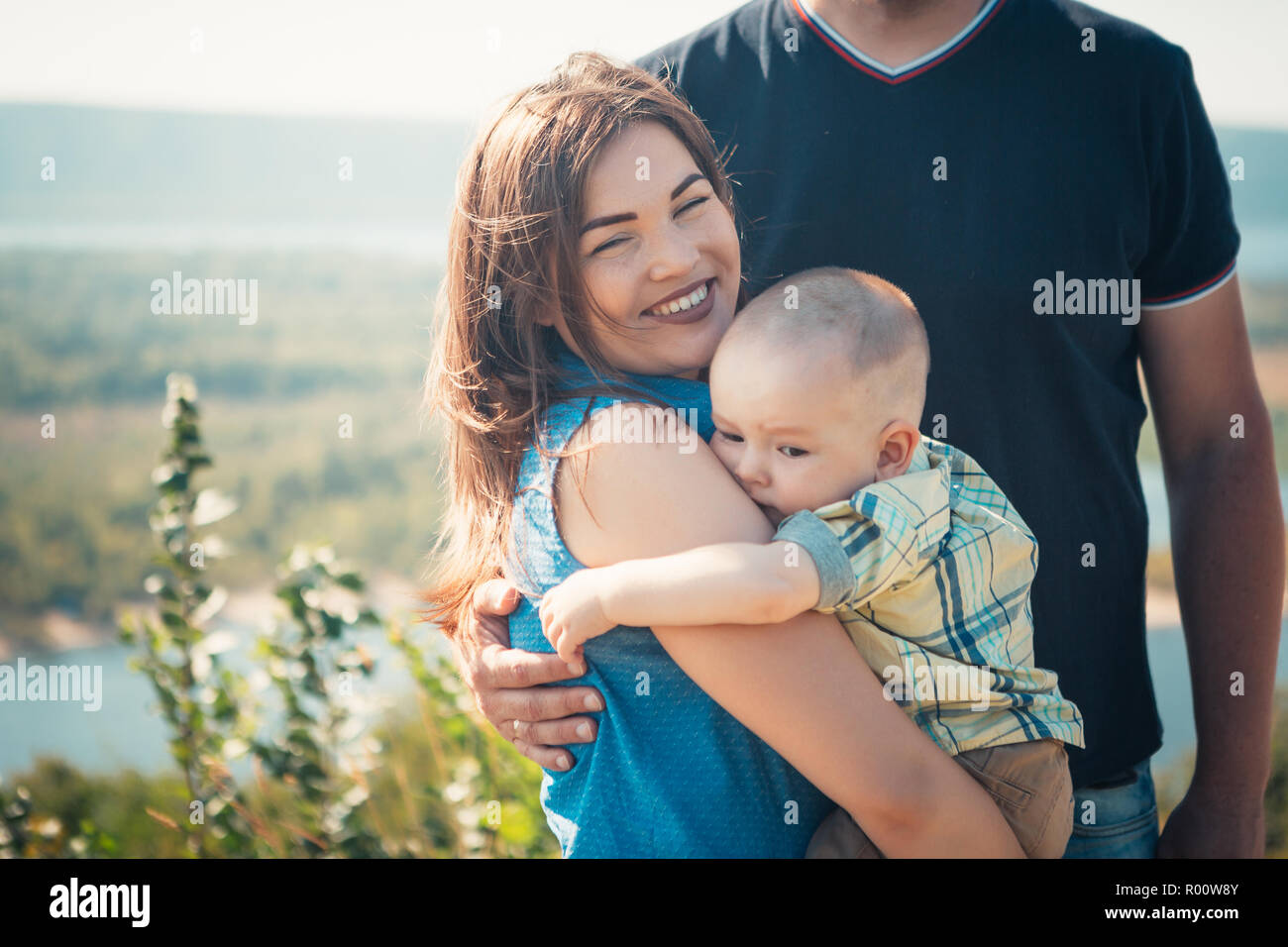 Happy family with baby son on nature background Stock Photo - Alamy