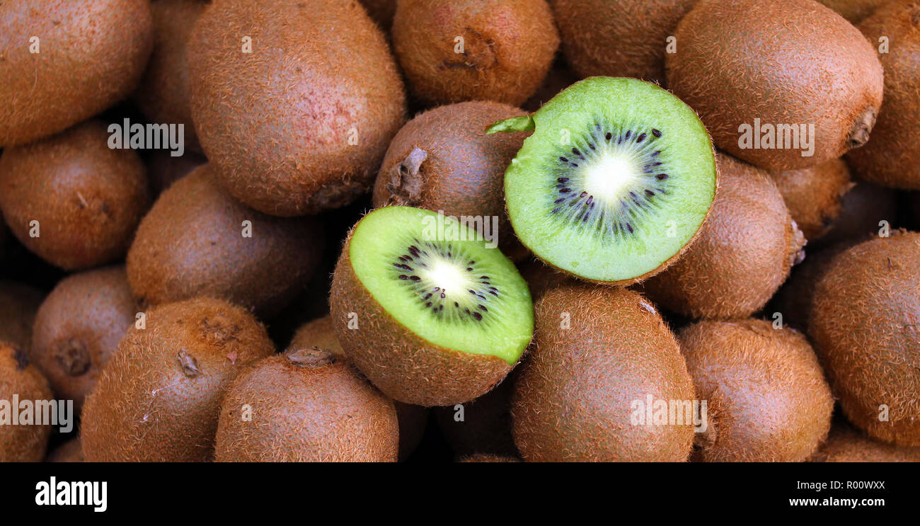 Kiwi. Fresh organic kiwis in knitted basket. Slice of colorful green ...