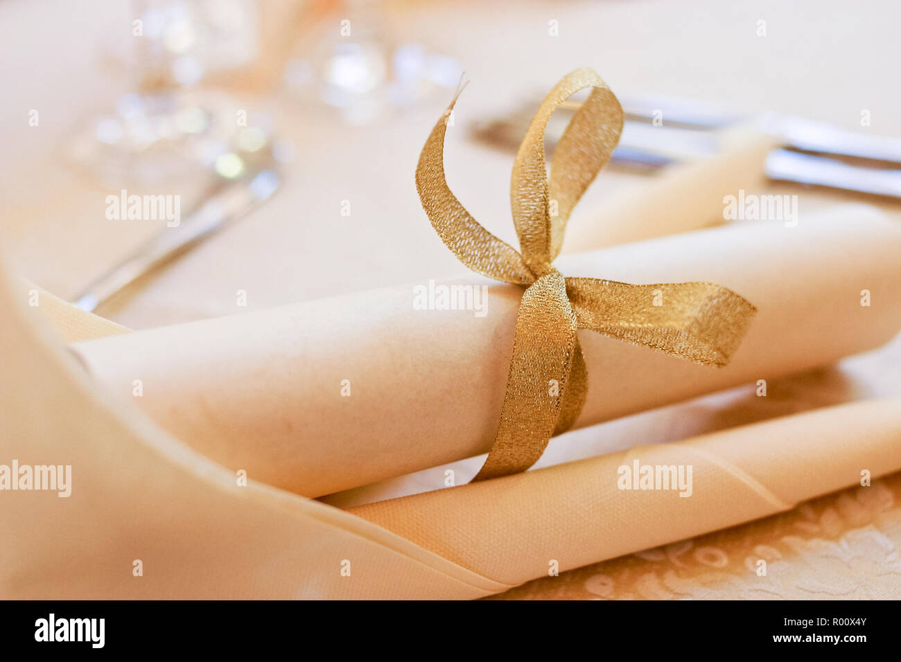 Menu roll tied with gold ribbon on banquet table Stock Photo - Alamy