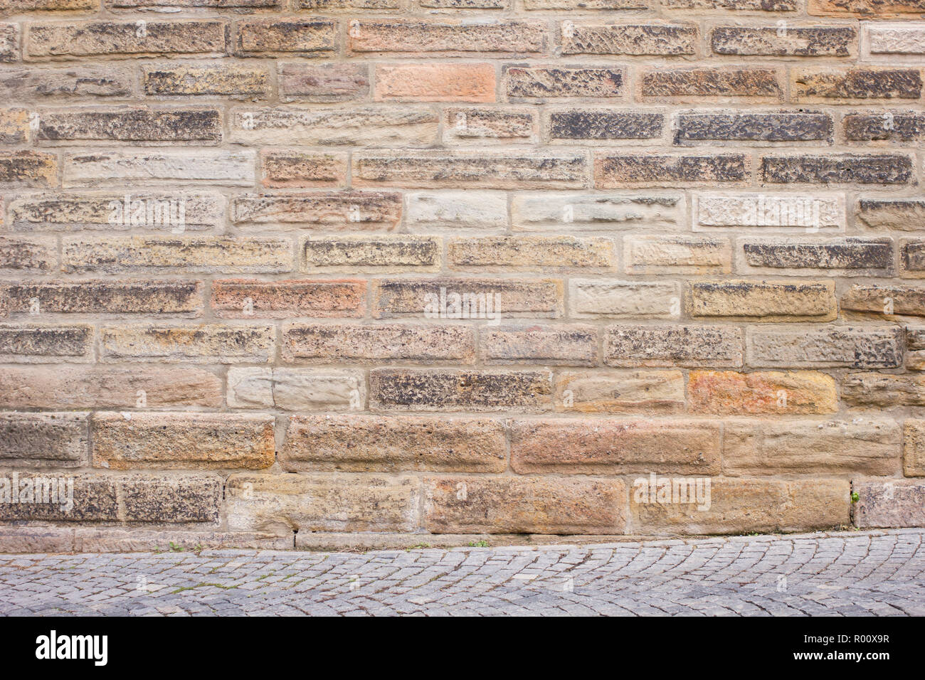 Old stone wall with regular mortar joins and cobbled street Stock Photo ...