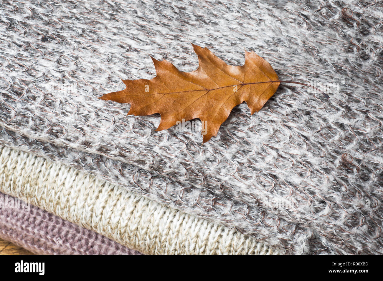 Crumpled gray knitted clothes folded in a pile. Texture for background ...