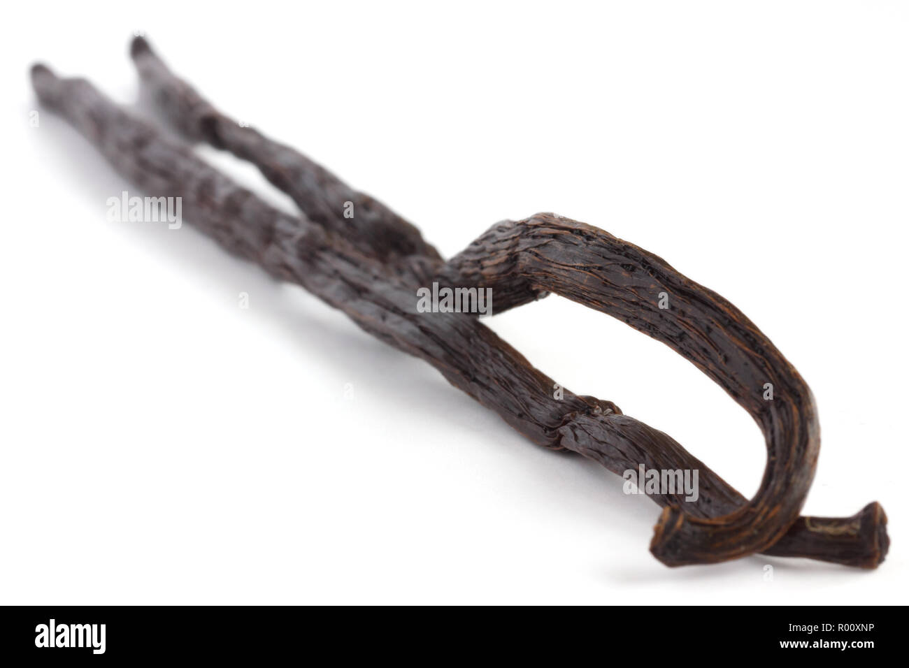 Two pods of whole vanilla on white Stock Photo - Alamy