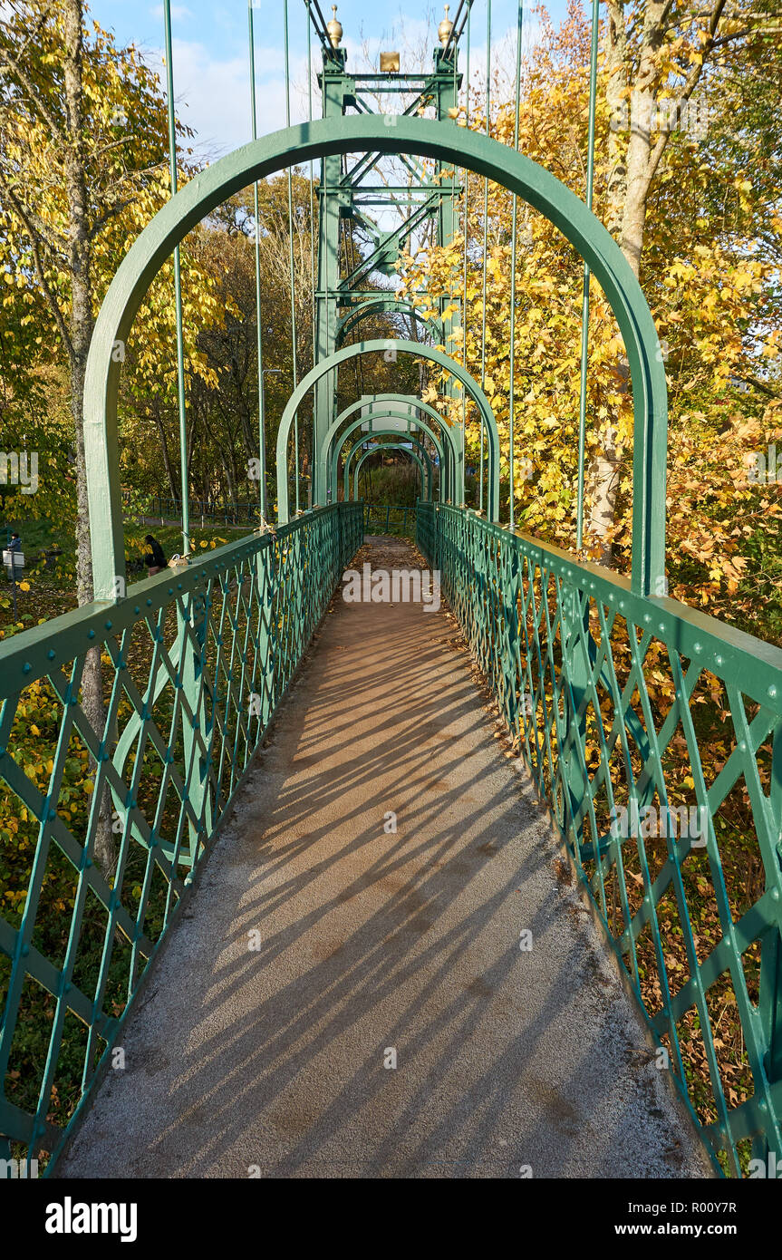 Iron suspension footbridge over the river Tummel in Pitlochry ...