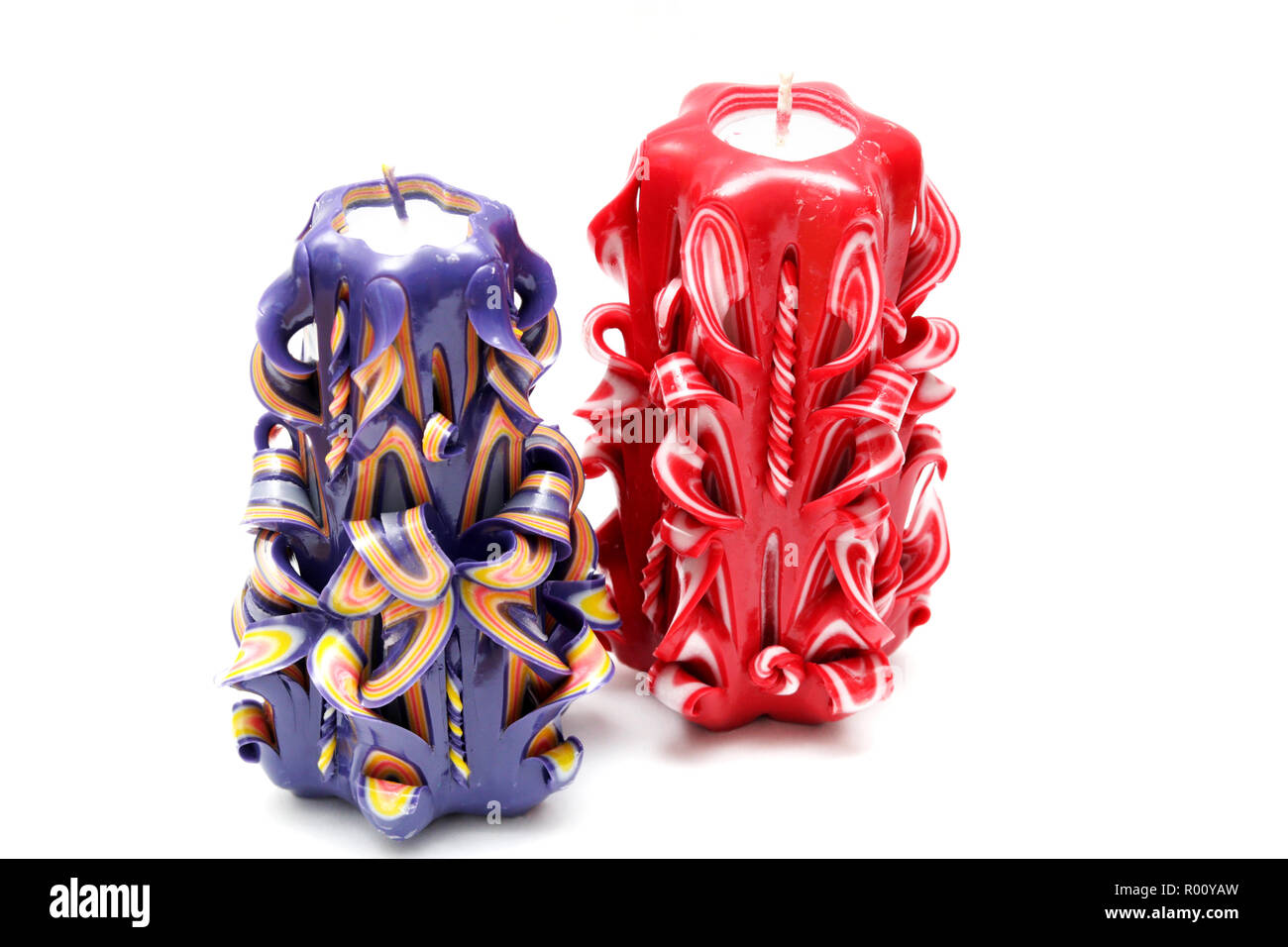 Two decorative carved handmade candles, isolated on white Stock Photo ...
