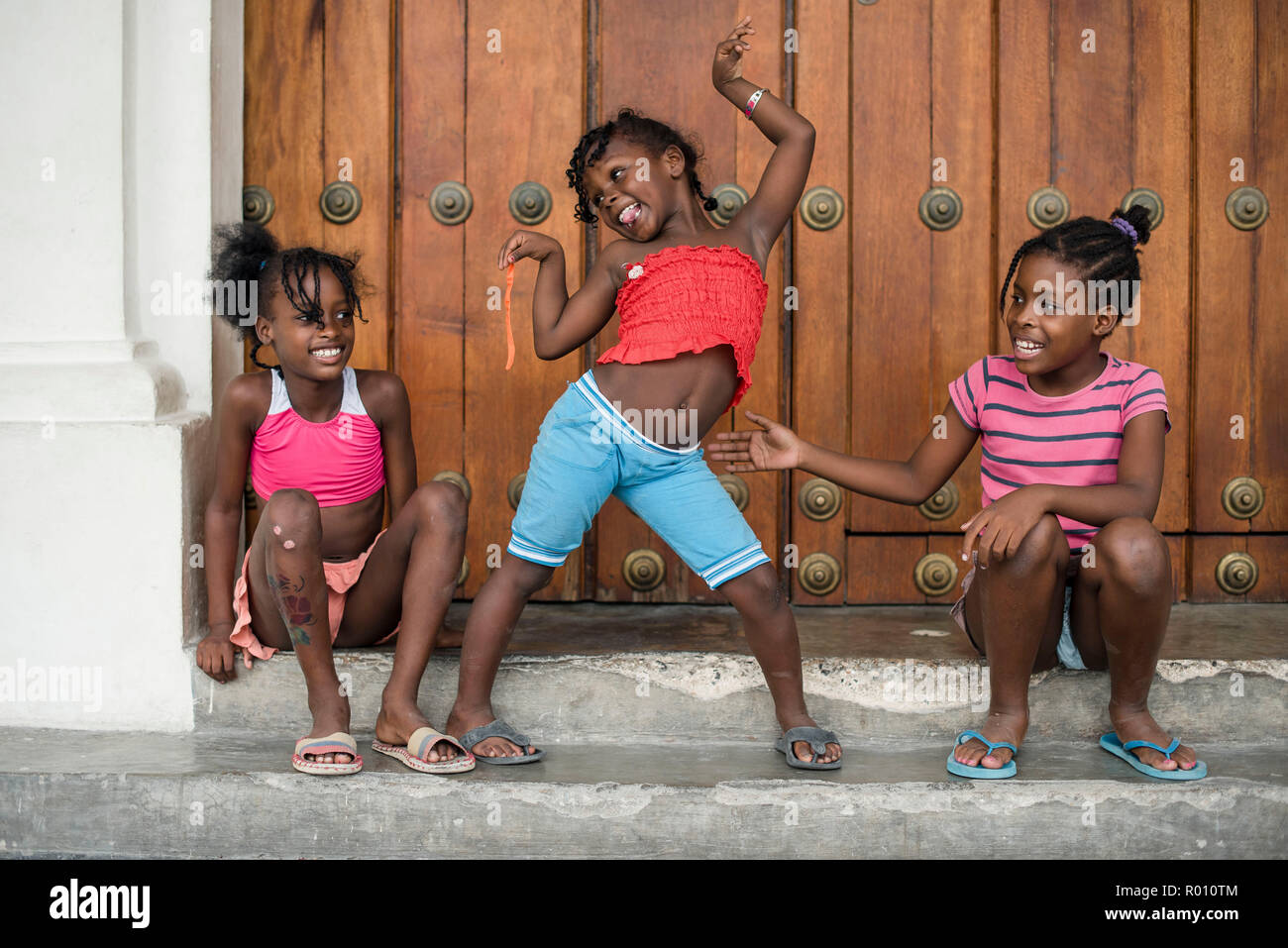 Some silly girls pose for the camera in a plaza in Havana, Cuba Stock Photo - Alamy