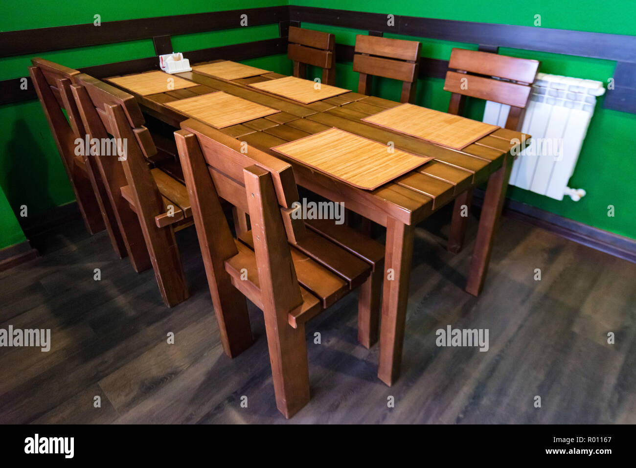 Wooden table for six people in restaurant Stock Photo - Alamy