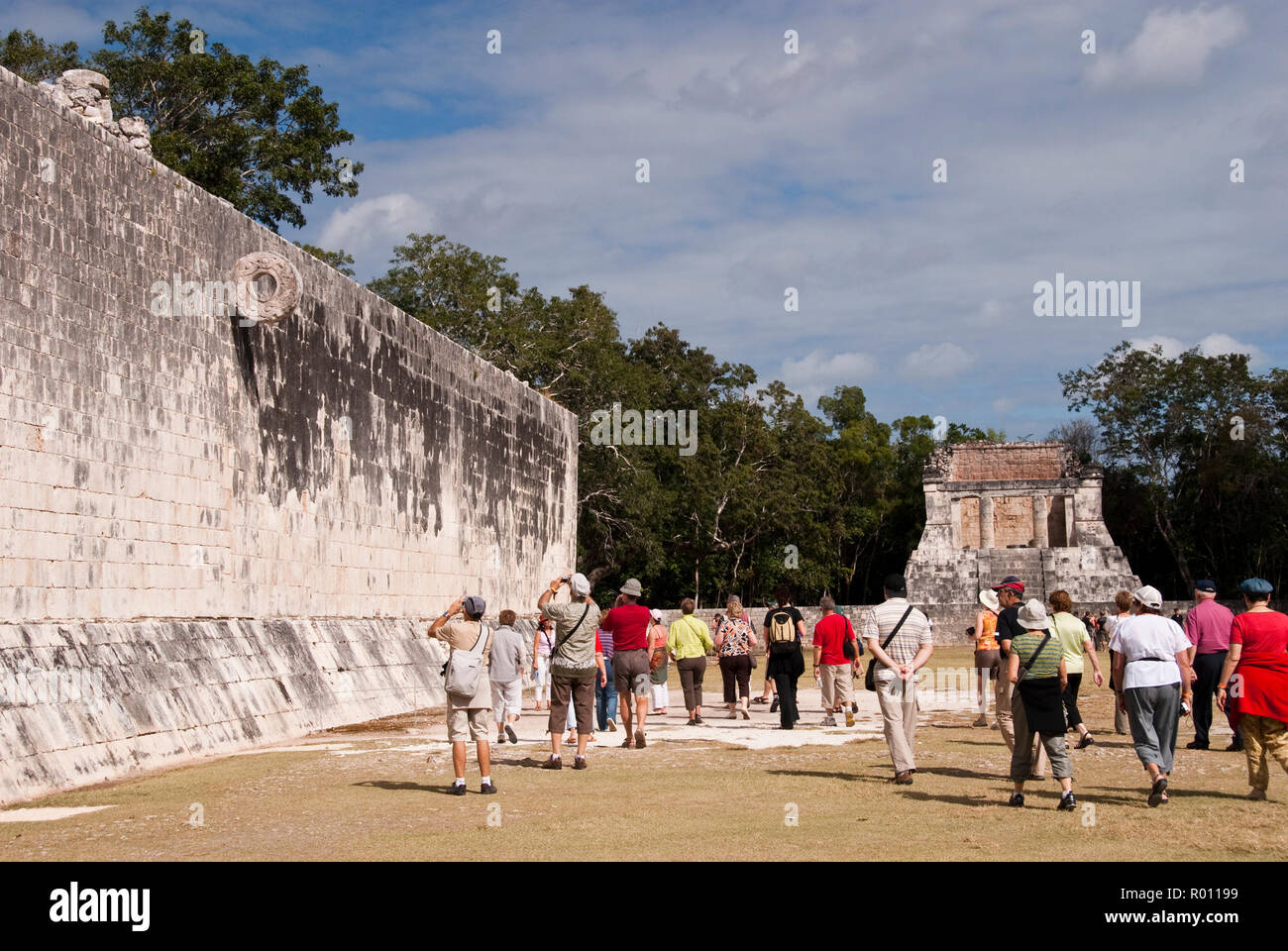 Tourists view the Great Ball Court (Gran Juego de Pelota), used to play ...