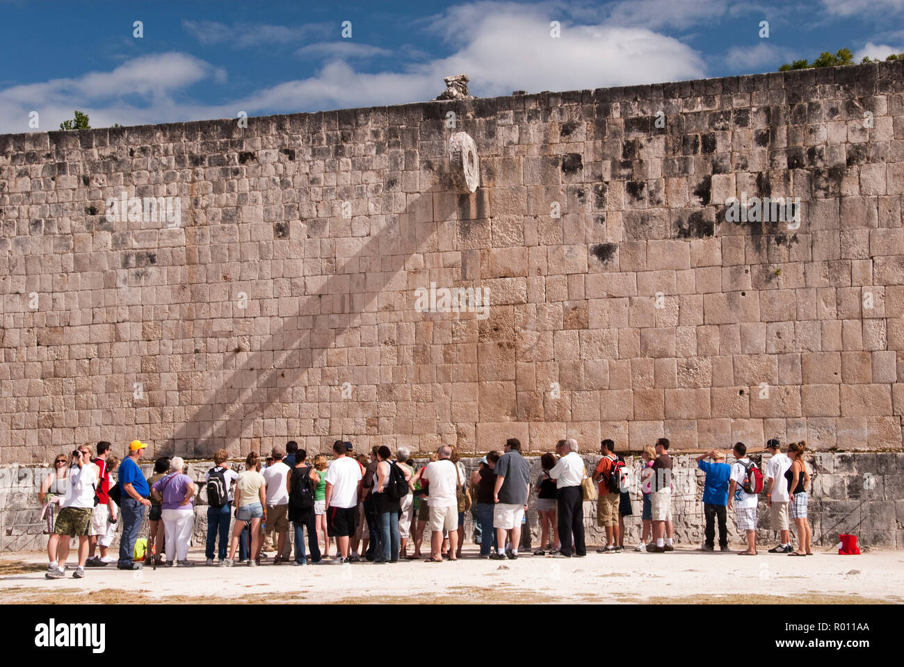 Tourists view the Great Ball Court (Gran Juego de Pelota), used to play ...