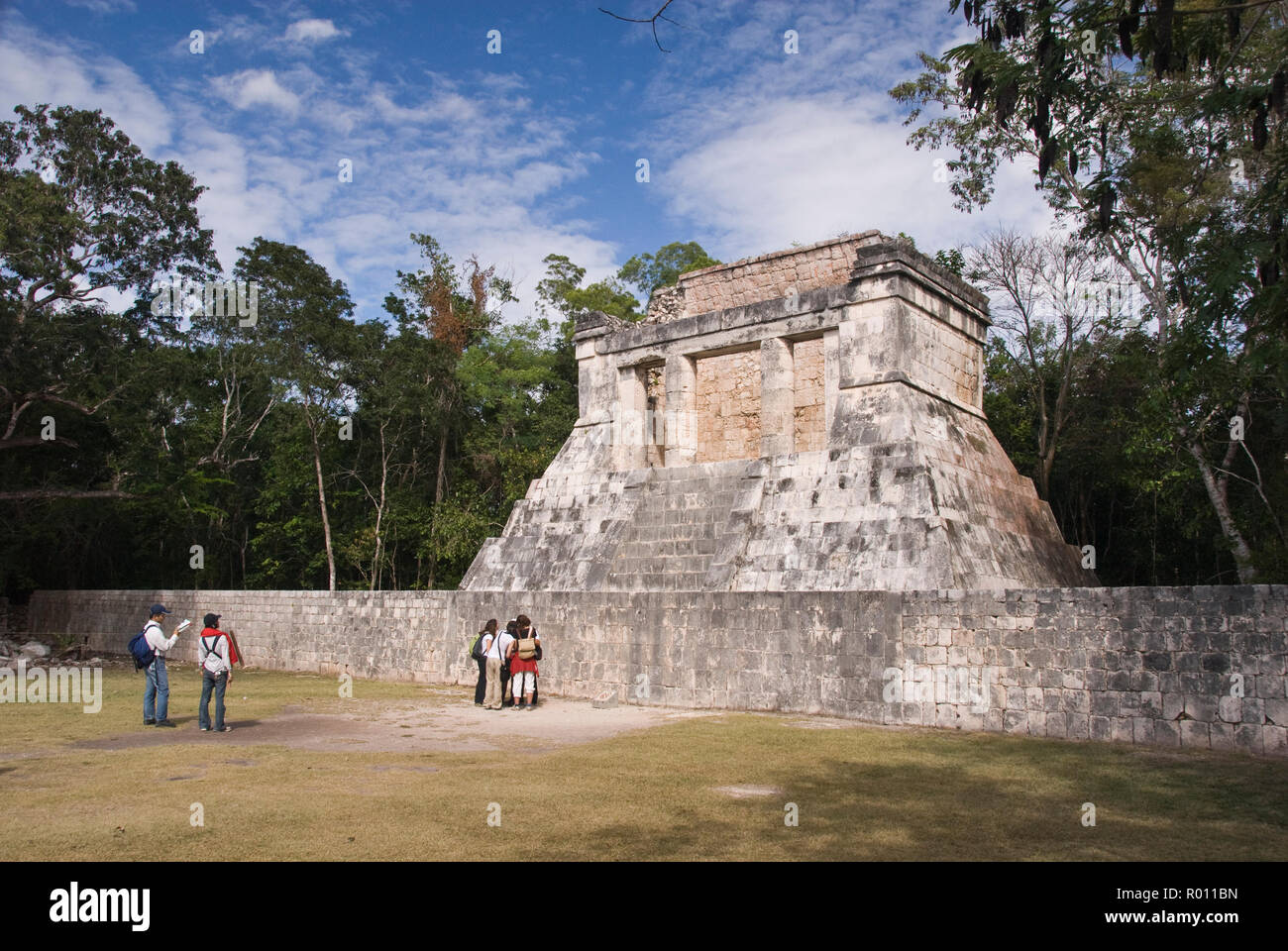 Tourists view the Temple of the Bearded Man, Chichen Itza, Yucatan ...