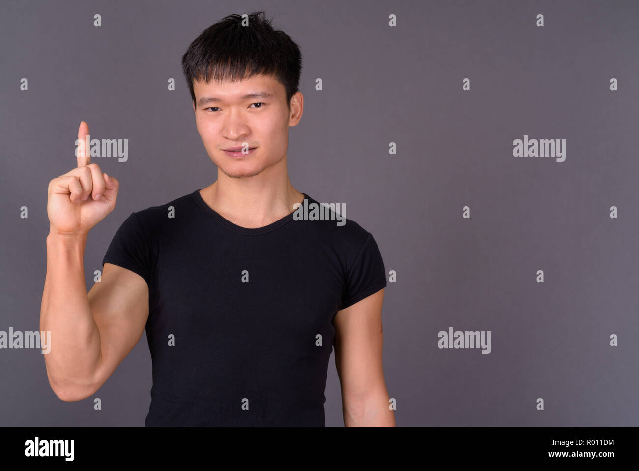 Young chinese man pointing hi-res stock photography and images - Alamy