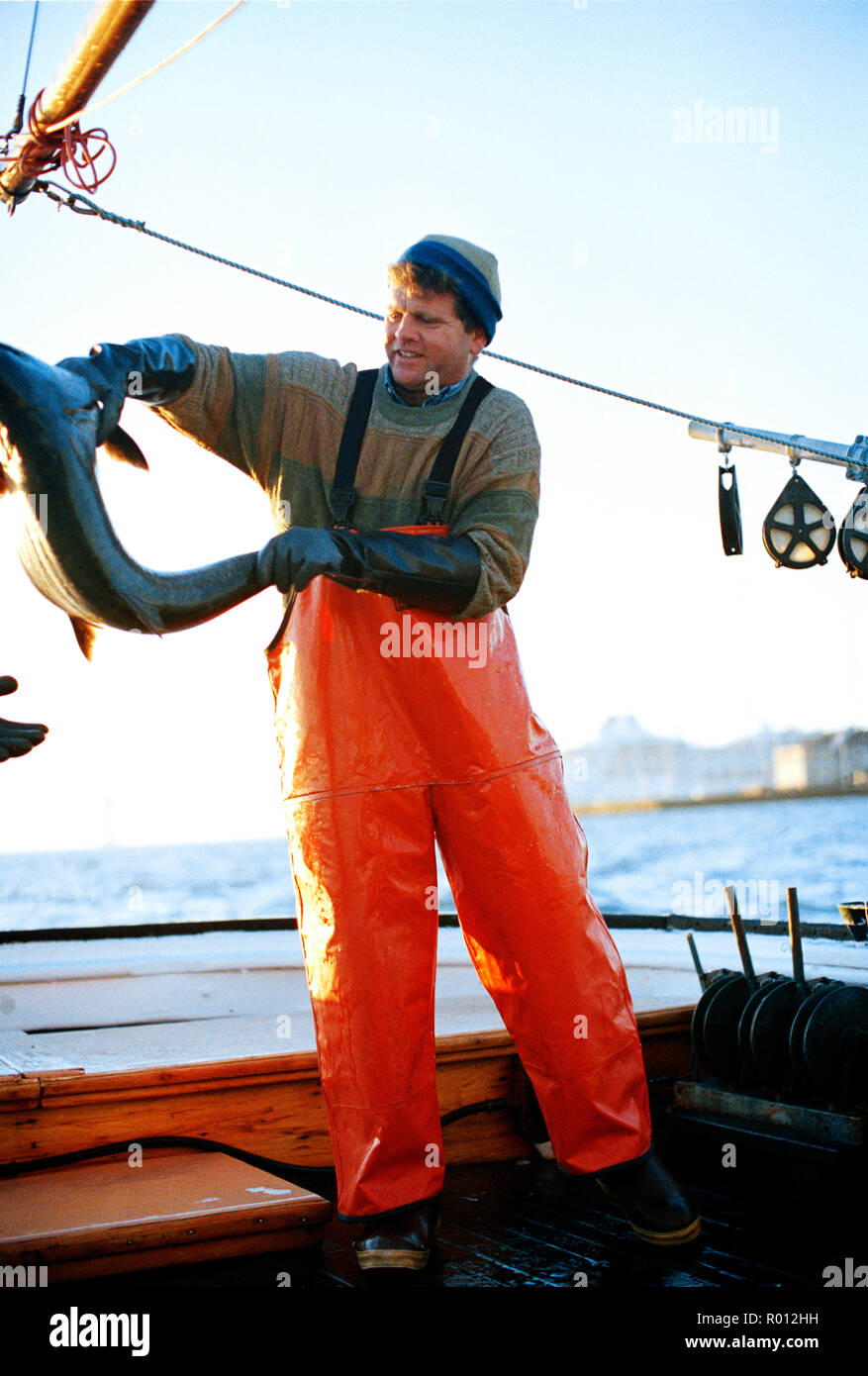 Fisherman working on boat deck Stock Photo - Alamy