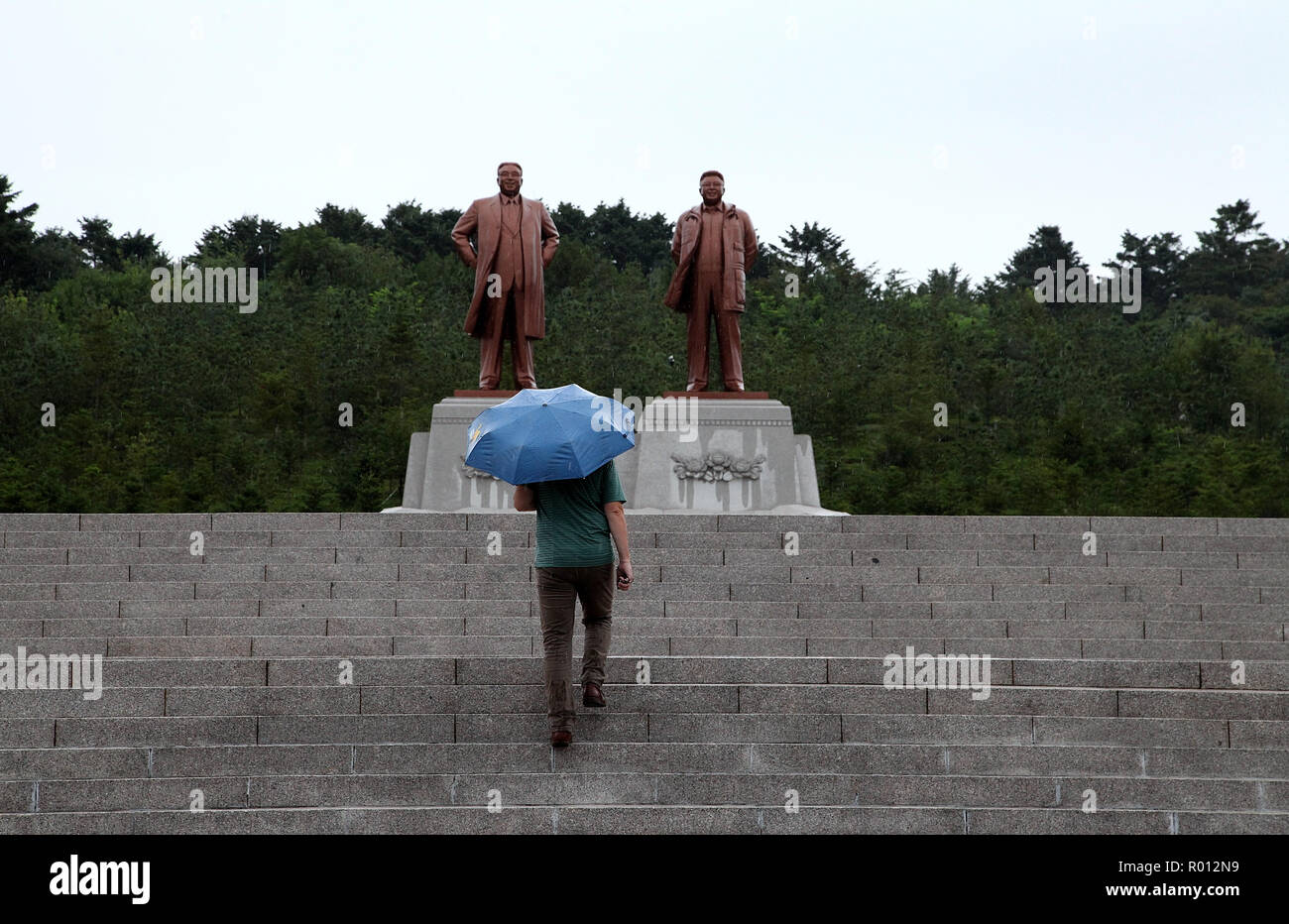 Tourist visiting the Kim statues at Kaesong in North Korea Stock Photo ...