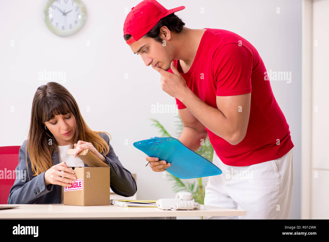 Courier delivering parcel to the office Stock Photo - Alamy