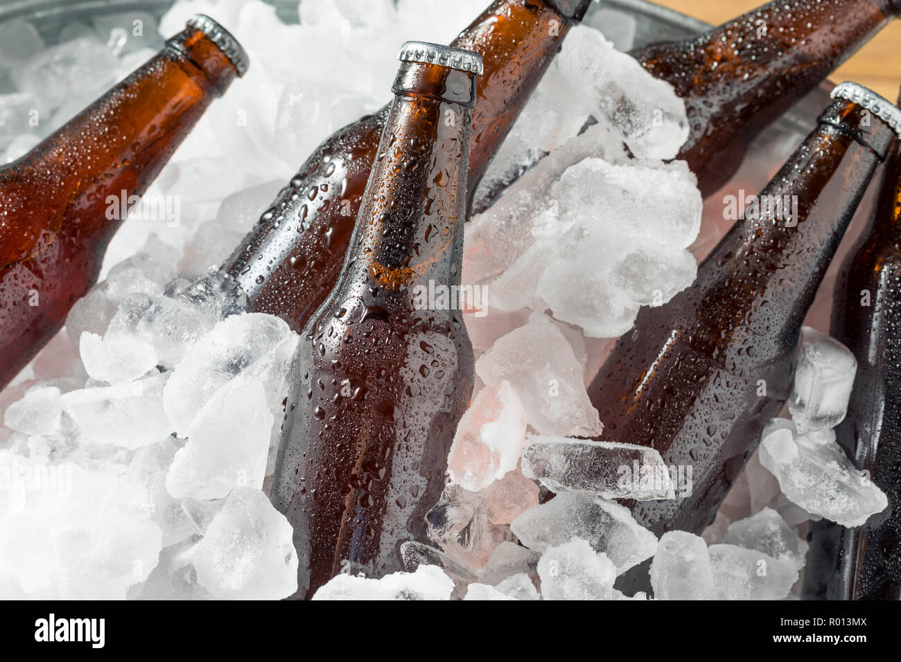 Cold Icy Beer Bottles in a Cooler with Ice Stock Photo - Alamy