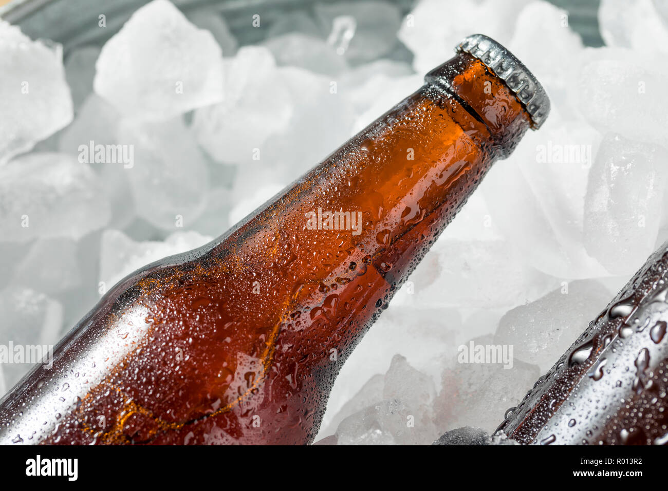 Cold Icy Beer Bottles in a Cooler with Ice Stock Photo - Alamy