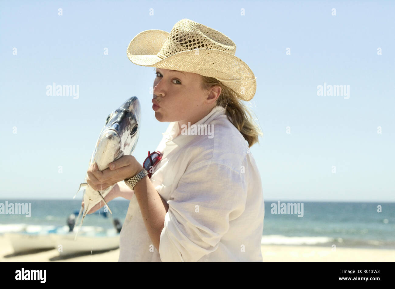 Woman kissing fish in Mexico Stock Photo - Alamy