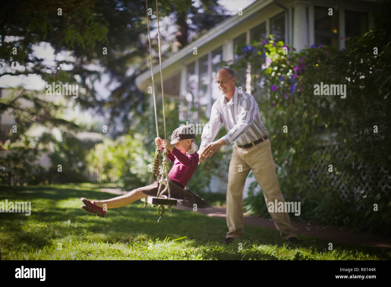 Young parents pushing daughter hi-res stock photography and images - Alamy