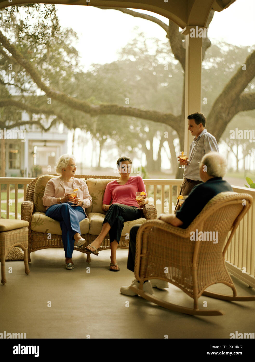 Family members socializing together on a suburban porch Stock Photo - Alamy
