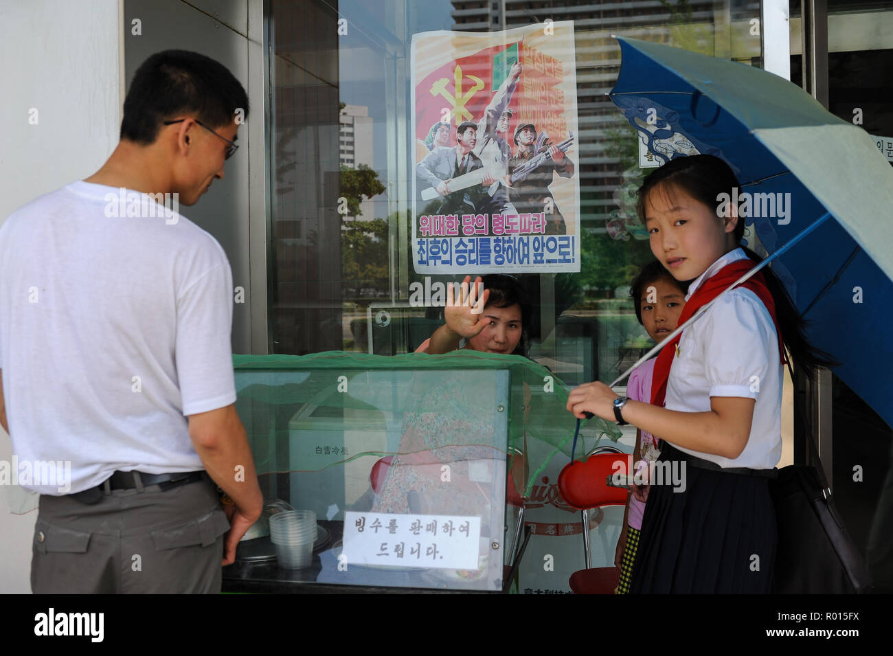 Pjoengjang, North Korea, An ice cream seller in front of a department ...