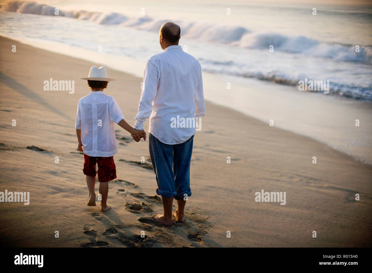 View of a little boy with his father on a beach Stock Photo - Alamy
