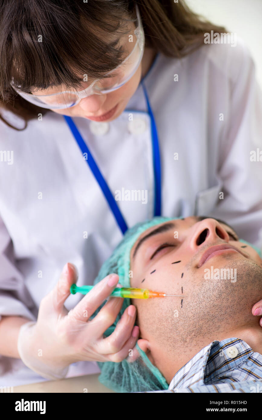Plastic surgeon preparing for operation on man face Stock Photo - Alamy