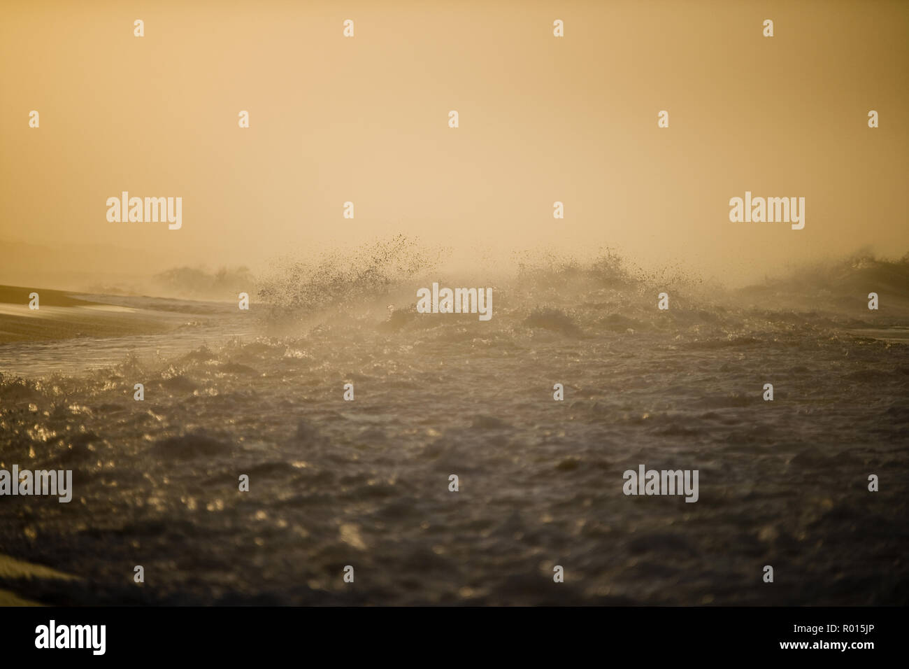 Rough water rushing towards land on a beach Stock Photo - Alamy