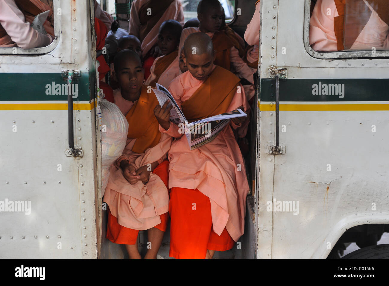 Yangon, Myanmar, Asia, A Buddhist nun reading newspaper Stock Photo - Alamy
