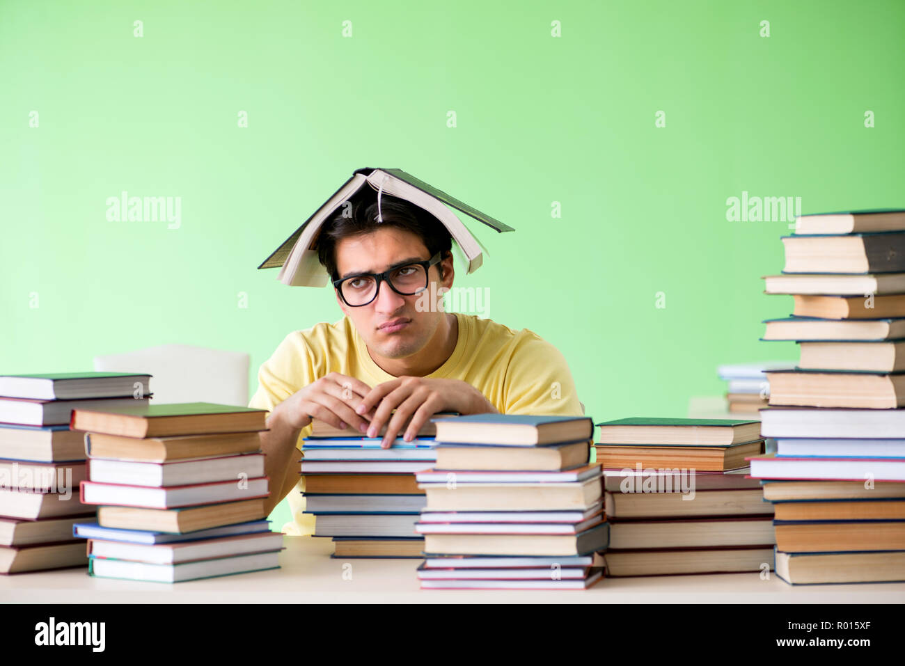 Student with too many books to read before exam Stock Photo - Alamy