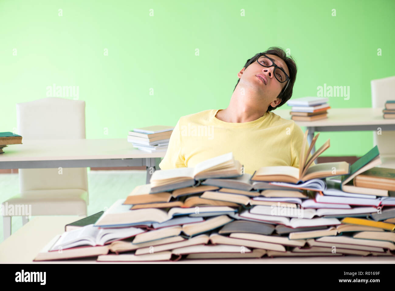 Student with too many books to read before exam Stock Photo - Alamy