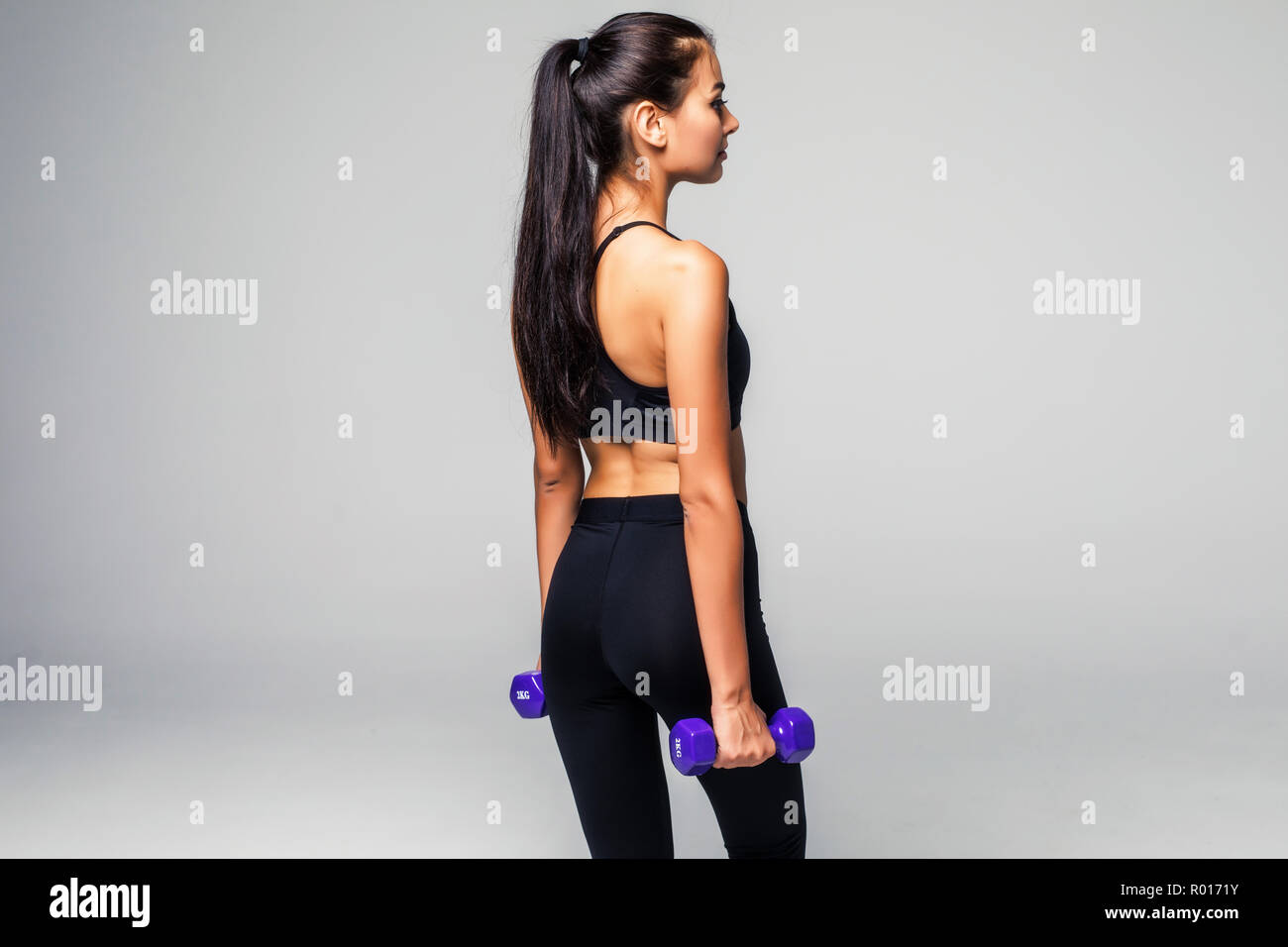 Strong woman working out with dumbbells, flexing her arm. Photo of ...