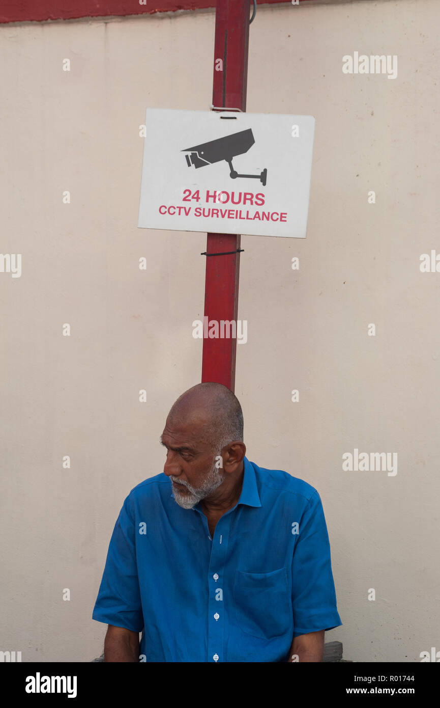 Singapore, Republic of Singapore, man sitting under a signboard Stock ...