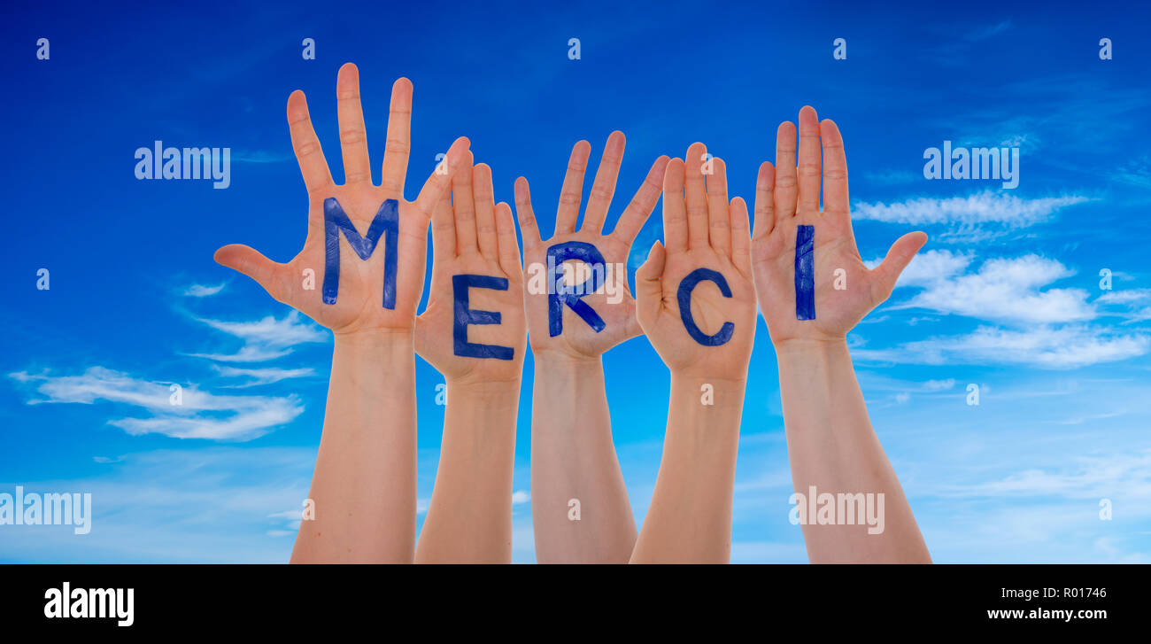 Many Hands Building Merci Means Thank You, Blue Sky Stock Photo - Alamy