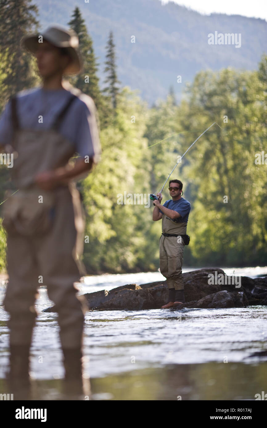 Men fishing on river Stock Photo - Alamy
