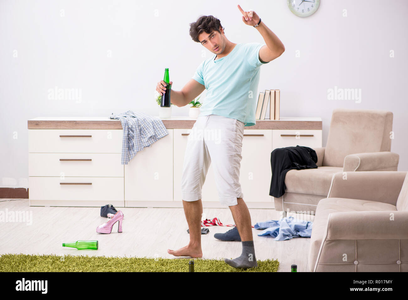 Young drunk handsome man after party at home Stock Photo - Alamy