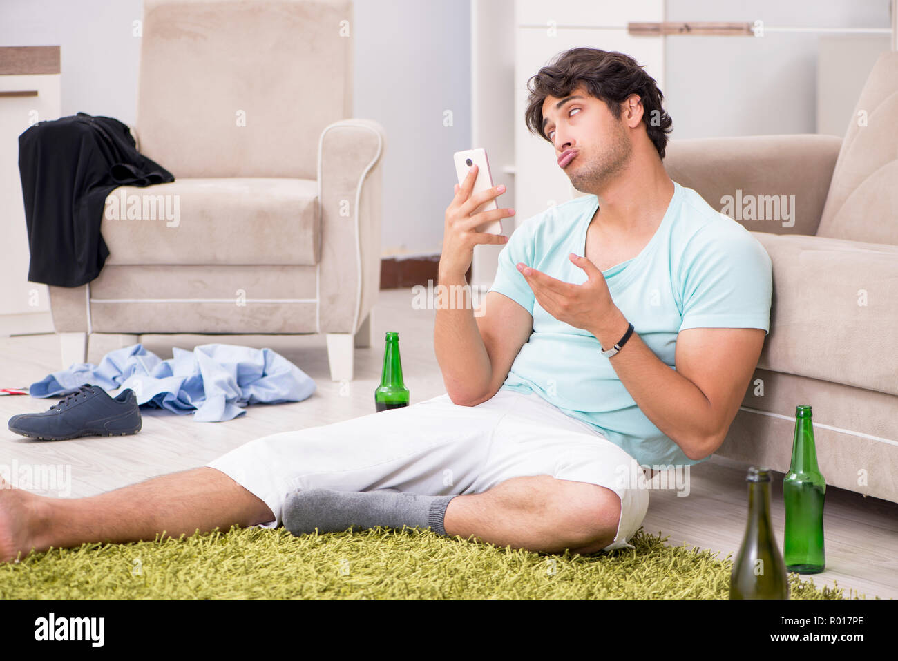 Young drunk handsome man after party at home Stock Photo - Alamy
